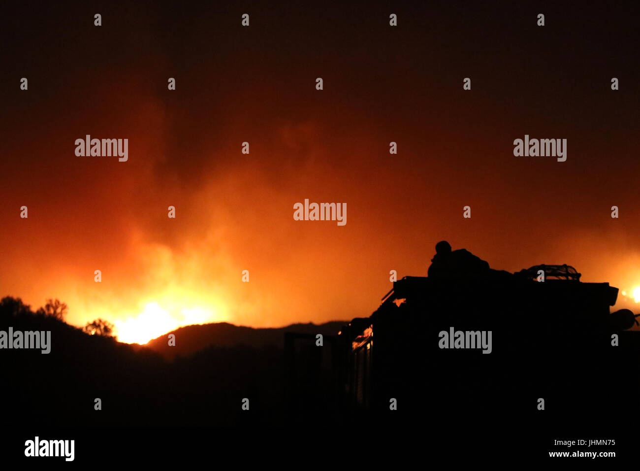 Goleta, California, USA. 14th July, 2017. A firefighter sits onto of ...