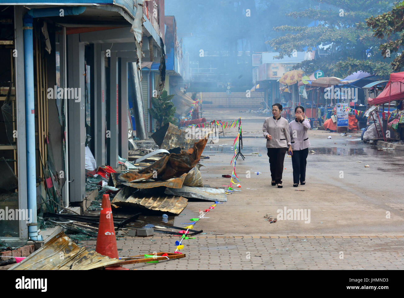 Vientiane, Laos. 15th July, 2017. Two women walk past the debris after ...