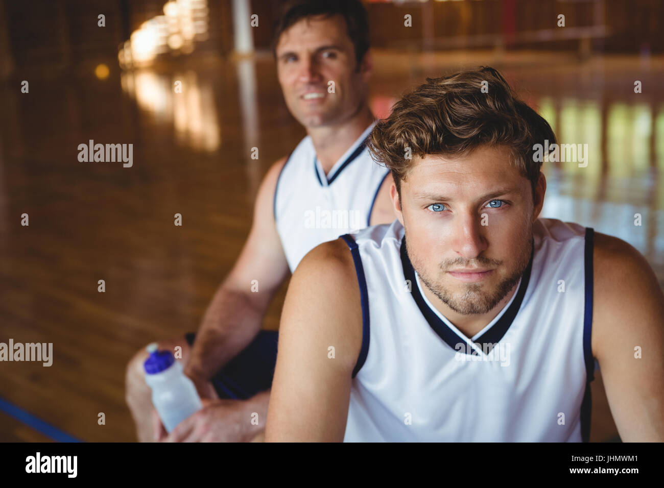 Close up portrait of basketball players sitting on bench in court Stock ...