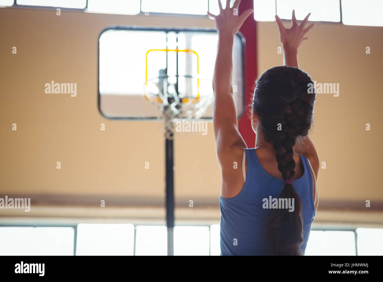 Rear view of female basketball player practicing in court Stock Photo ...