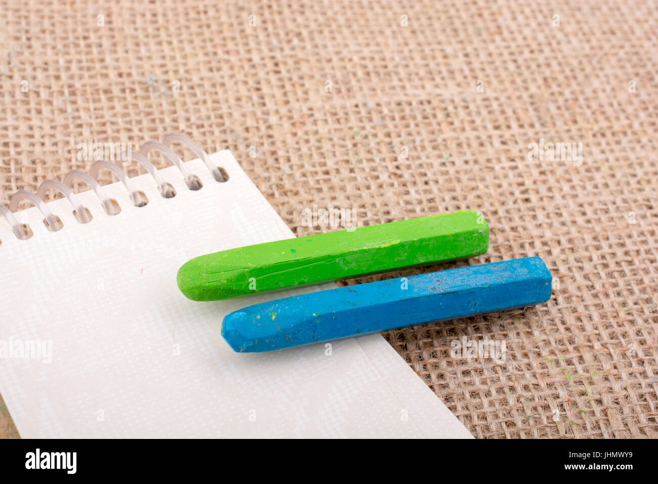 Colorful crayons placed on the notebook Stock Photo - Alamy