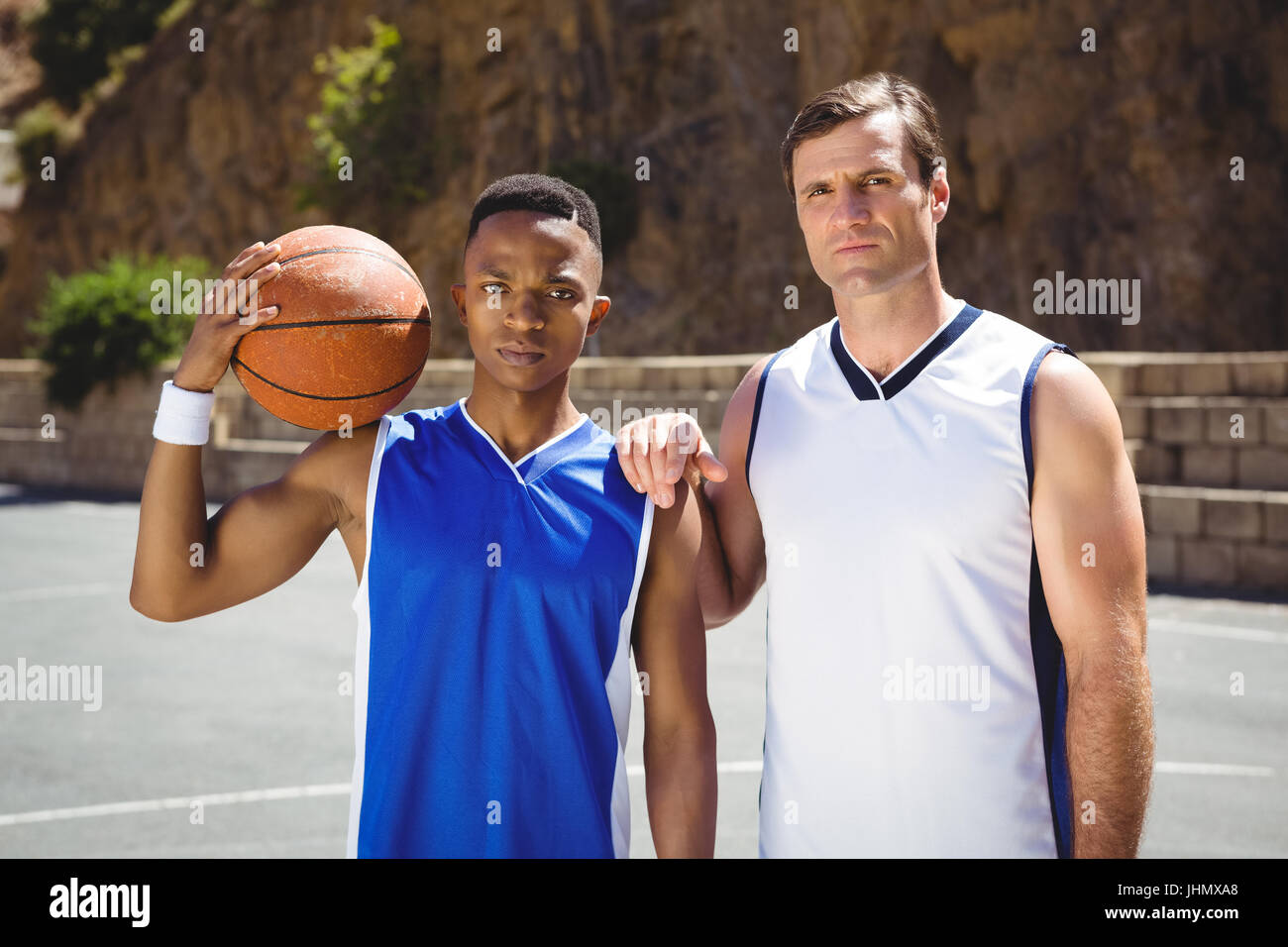 Portrait of teenage boy with man standing in court Stock Photo - Alamy