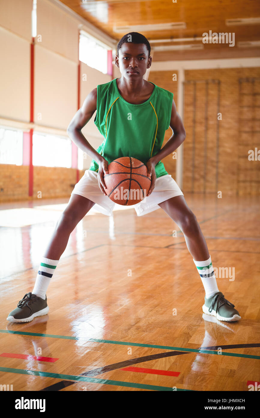 Portrait of teenage basketball player playing in court Stock Photo - Alamy