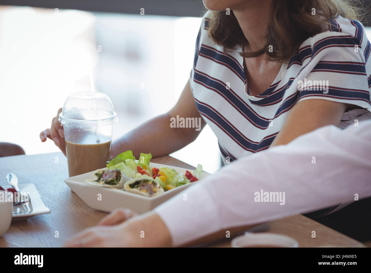 High angle view of business colleagues having breakfast on table at ...