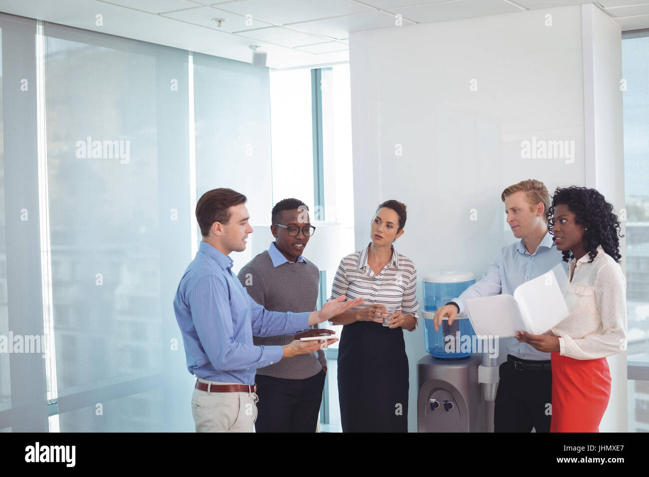 Woman standing water cooler hi-res stock photography and images - Alamy