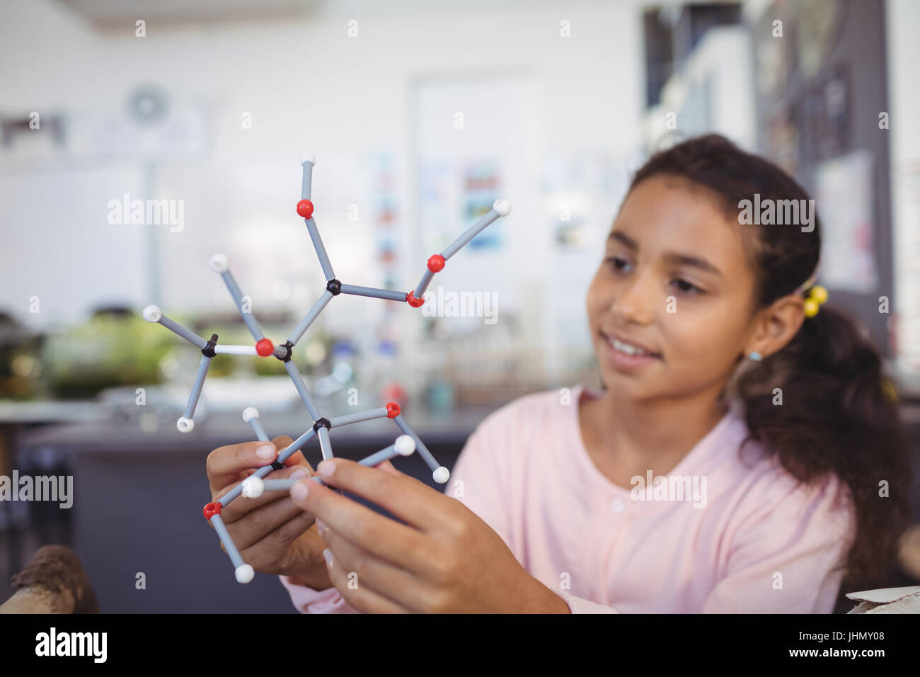 Elementary student holding molecule model at science laboratory Stock ...