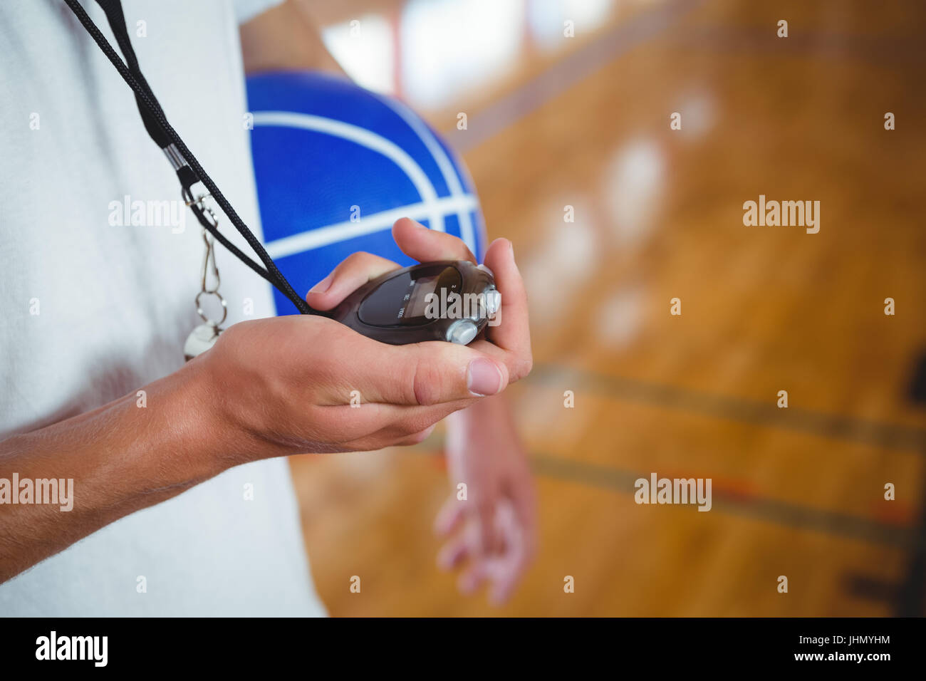 Midsection of basketball coach with stopwatch standing in court Stock ...