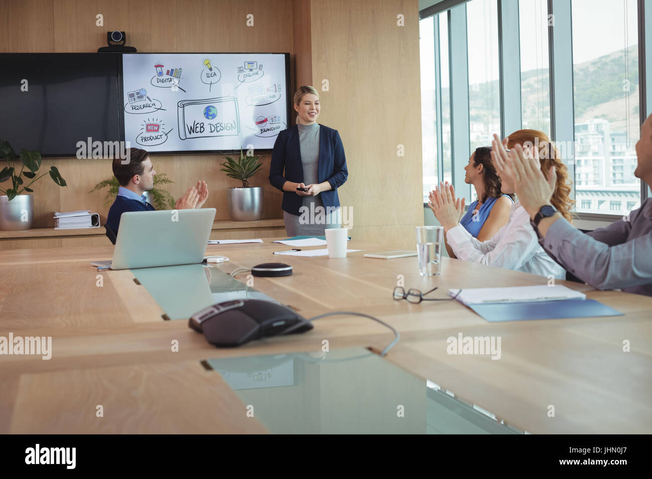 Colleagues clapping during meeting in board room Stock Photo - Alamy