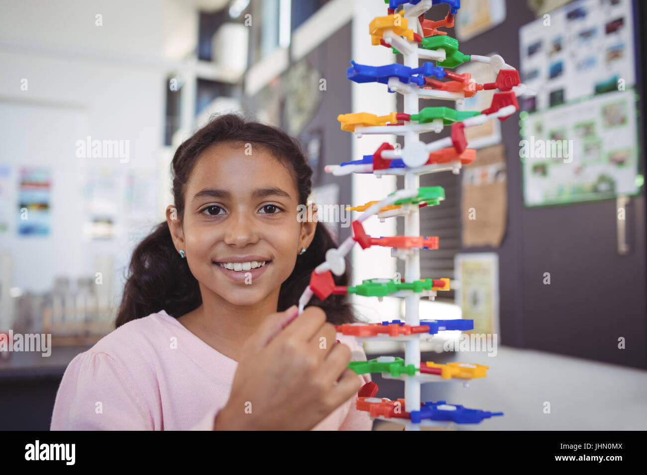 Portrait of smiling elementary student by model in classroom Stock ...
