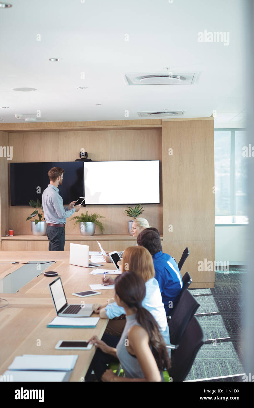 High angle view of business people at conference table during meeting ...
