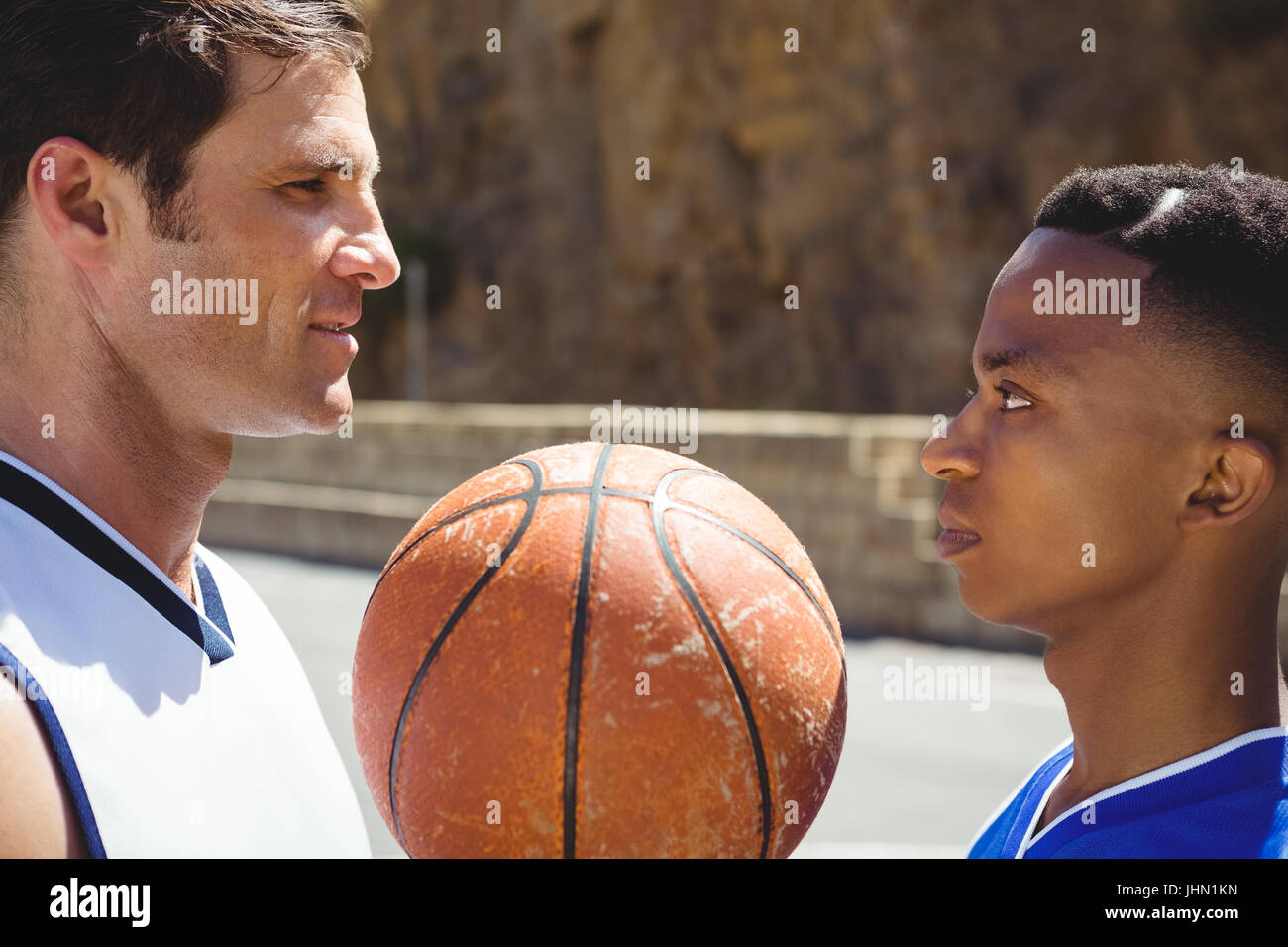 Side view of basketball players standing face to face in court Stock ...