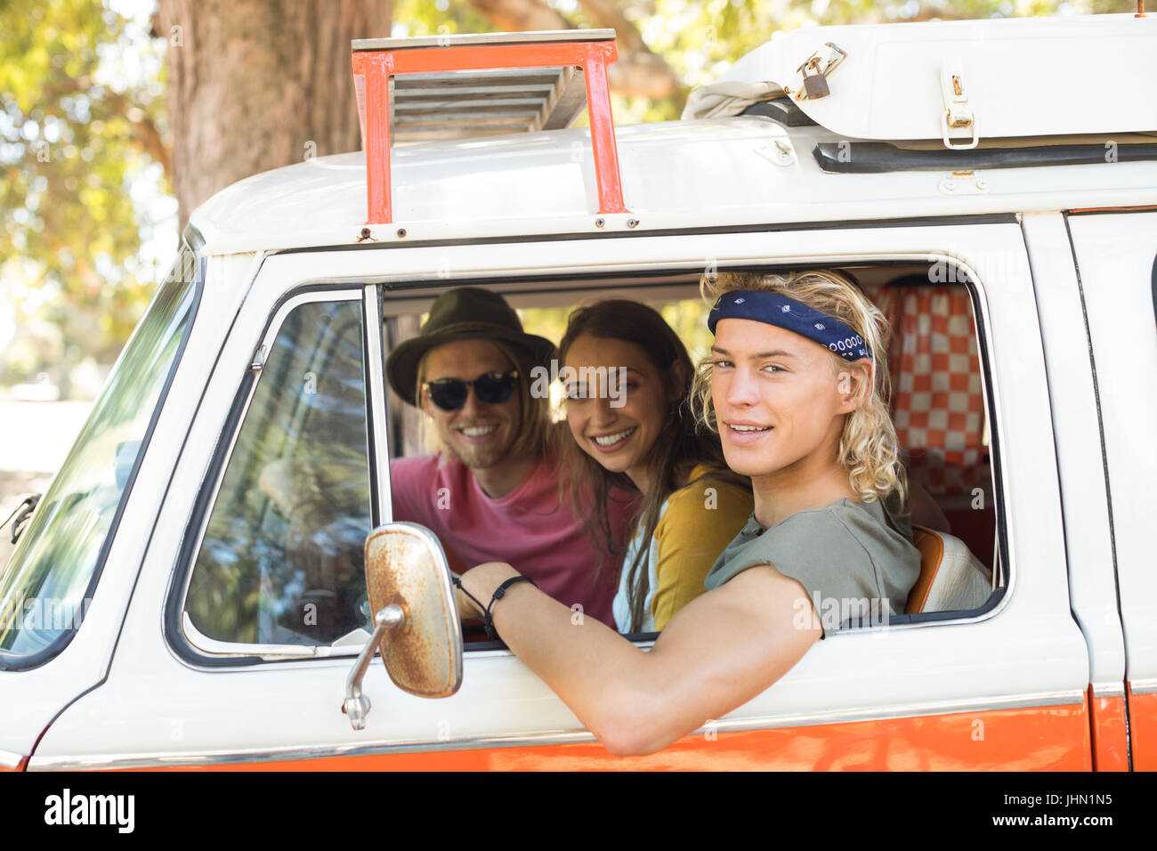 Portrait of friends sitting in camper van Stock Photo - Alamy