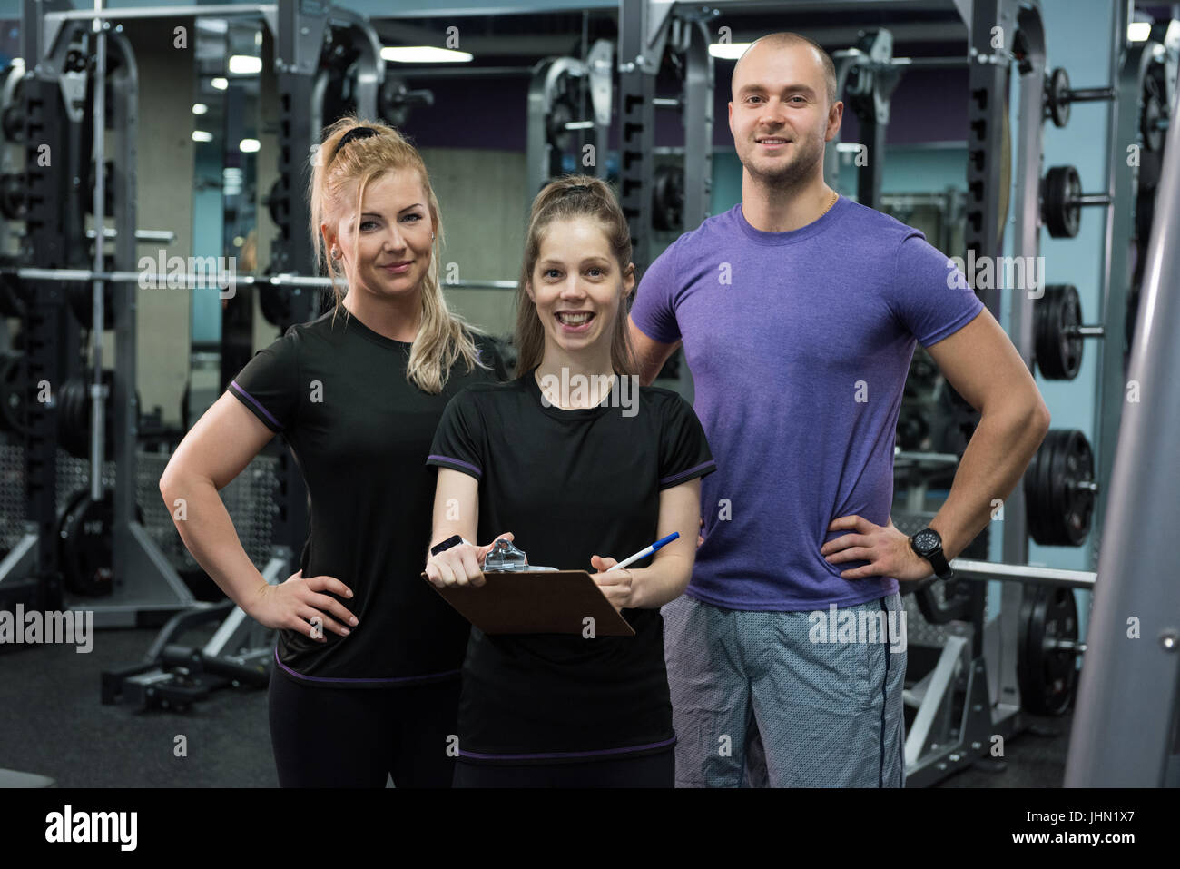 Portrait of smiling friends standing together at gym Stock Photo - Alamy