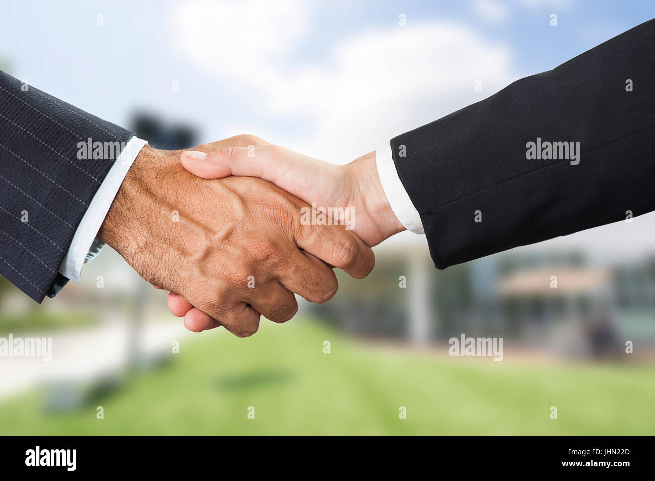 Two businessman shaking hands Stock Photo - Alamy