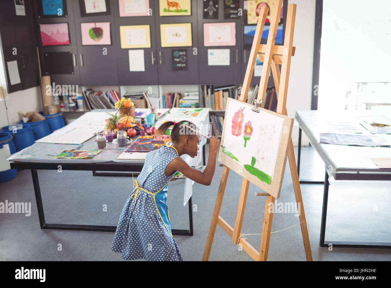 High angle view of focused girl painting on canvas in classroom Stock ...