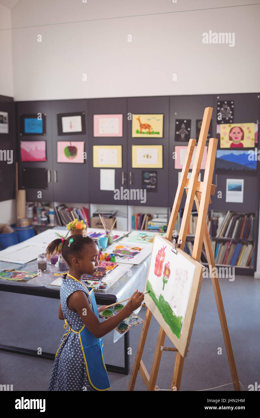 High angle side view of girl painting on canvas in classroom Stock ...
