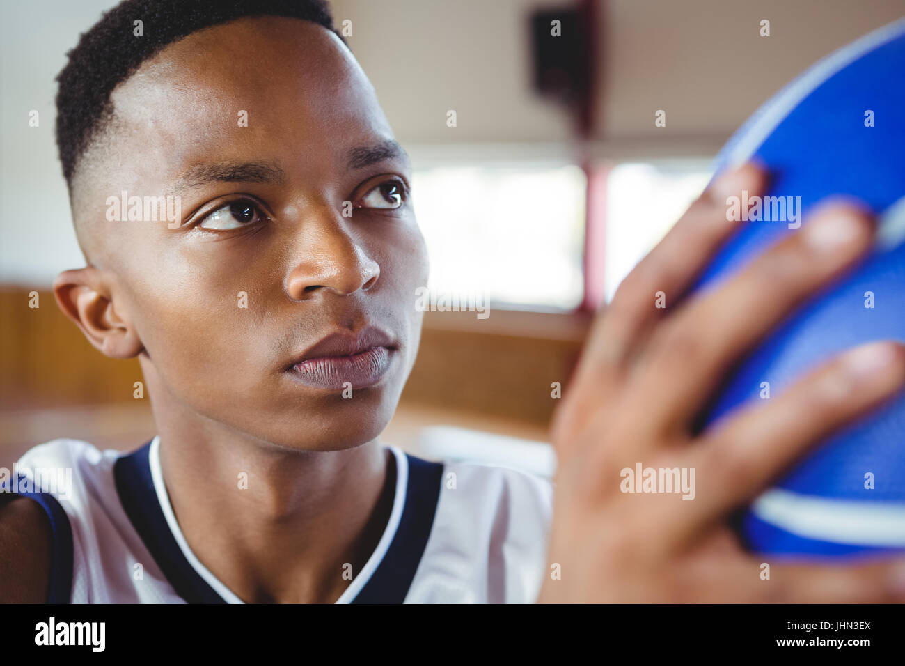 Close up of teenage boy practicing basketball in court Stock Photo - Alamy