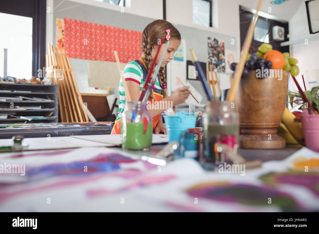 Girl painting in classroom at art school Stock Photo - Alamy
