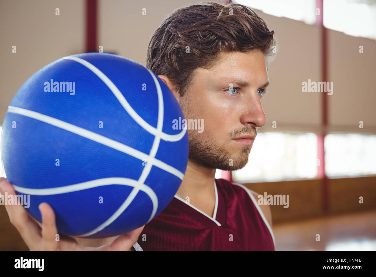 Serious basketball player holding hi-res stock photography and images ...
