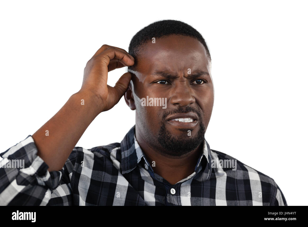 Confused man standing against white background Stock Photo - Alamy