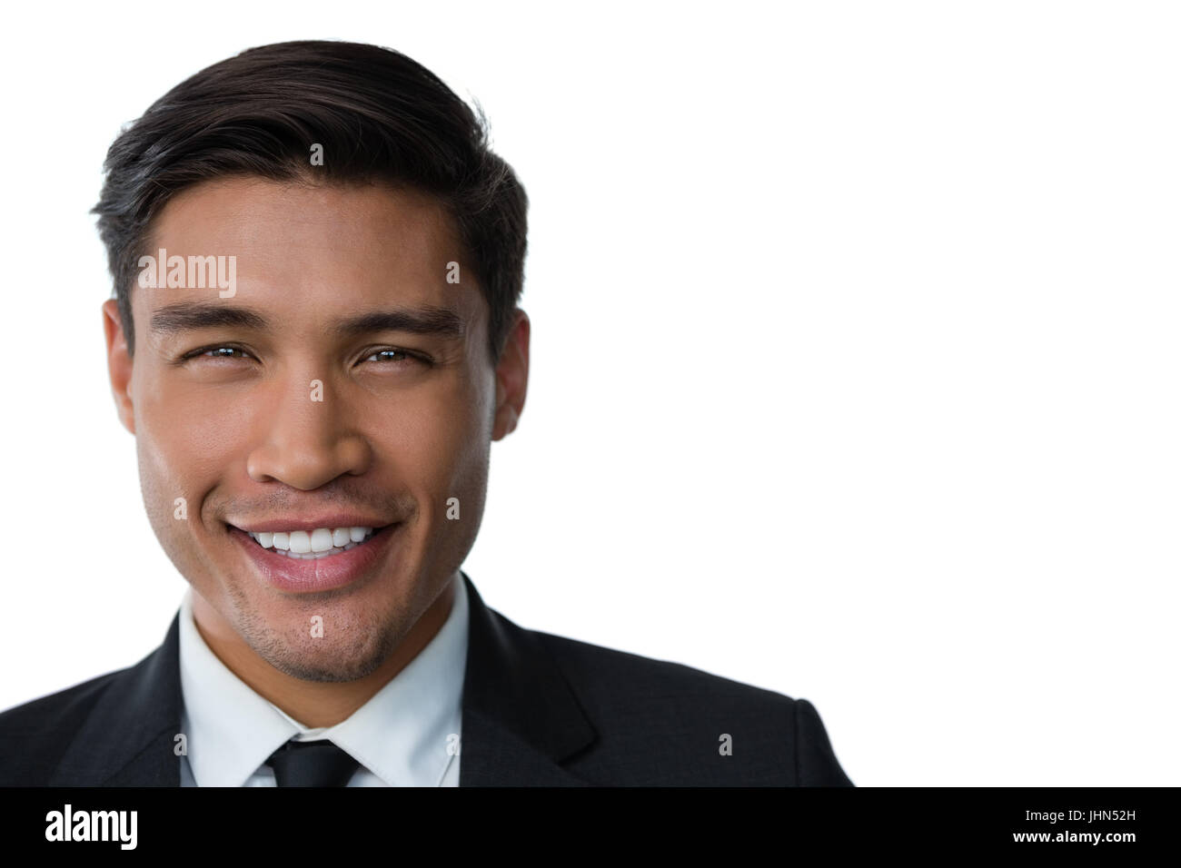 Close up portrait of young smiling businessman against white background ...