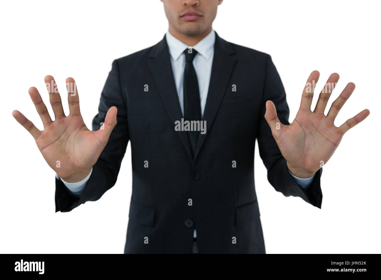Mid section of businessman touching invisible interface while standing ...