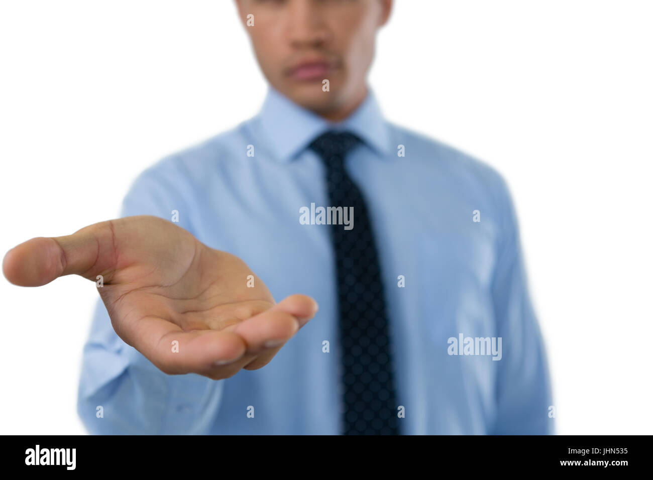 Mid section of businessman extending hand against white background ...