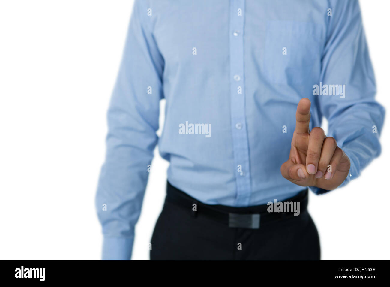 Mid section of businessman touching invisible screen standing against ...
