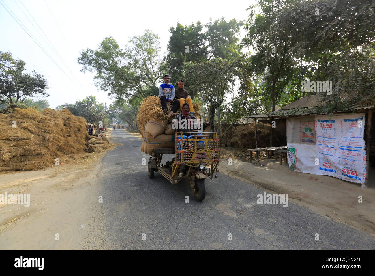 A locally made three-wheeler van carrying harvested paddy Nachole ...