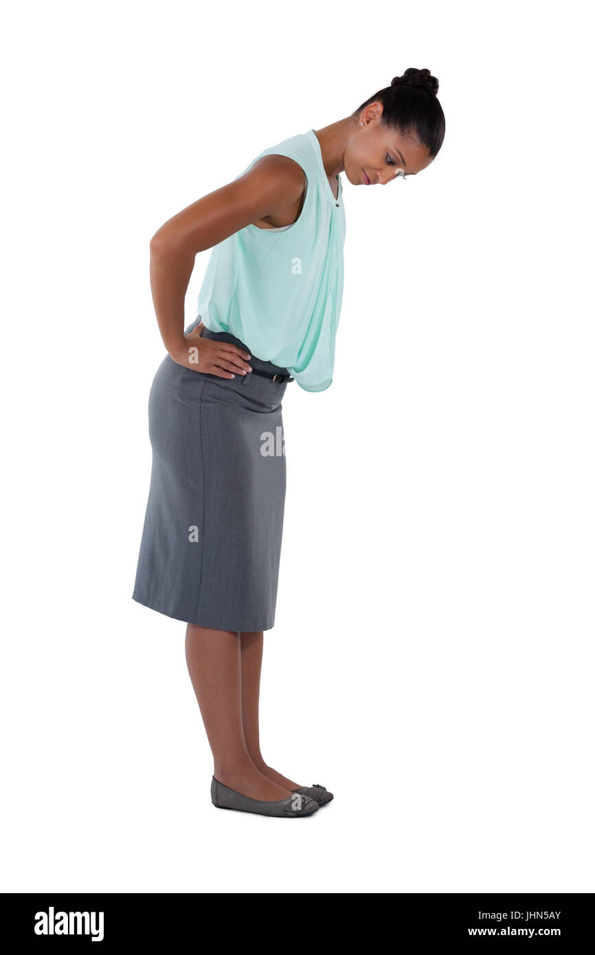 Businesswoman bending and looking down against white background Stock ...