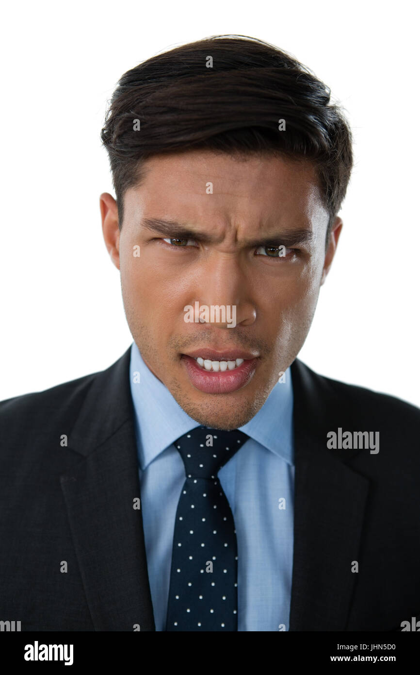 Portrait of displeased businessman against white background Stock Photo ...