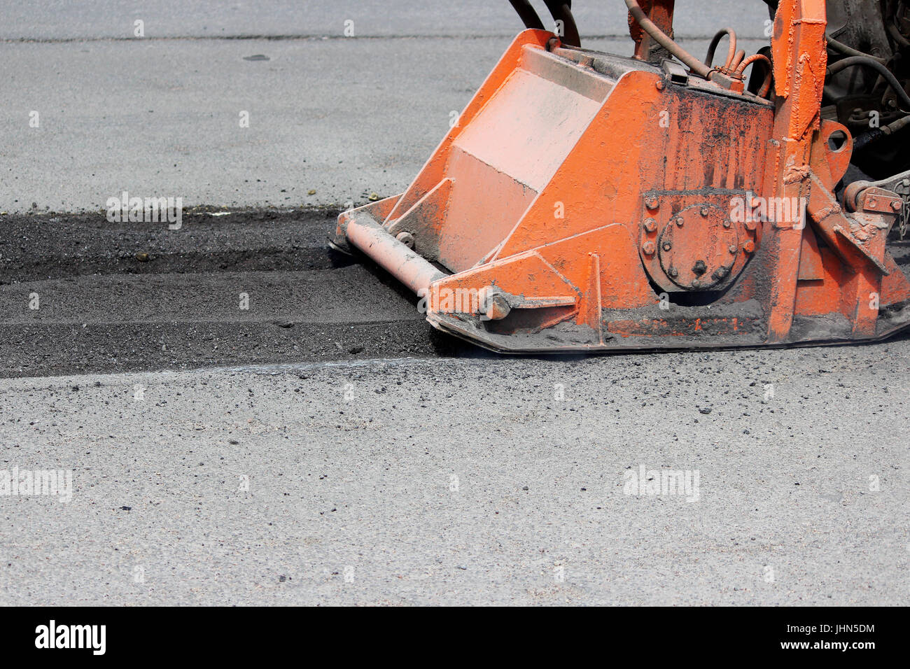 A tractor with a nozzle repairs the road. Patch repair to pits Stock ...