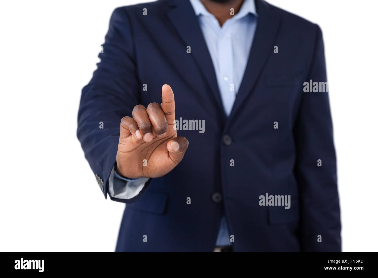 Mid section of businessman pressing an invisible virtual screen Stock ...
