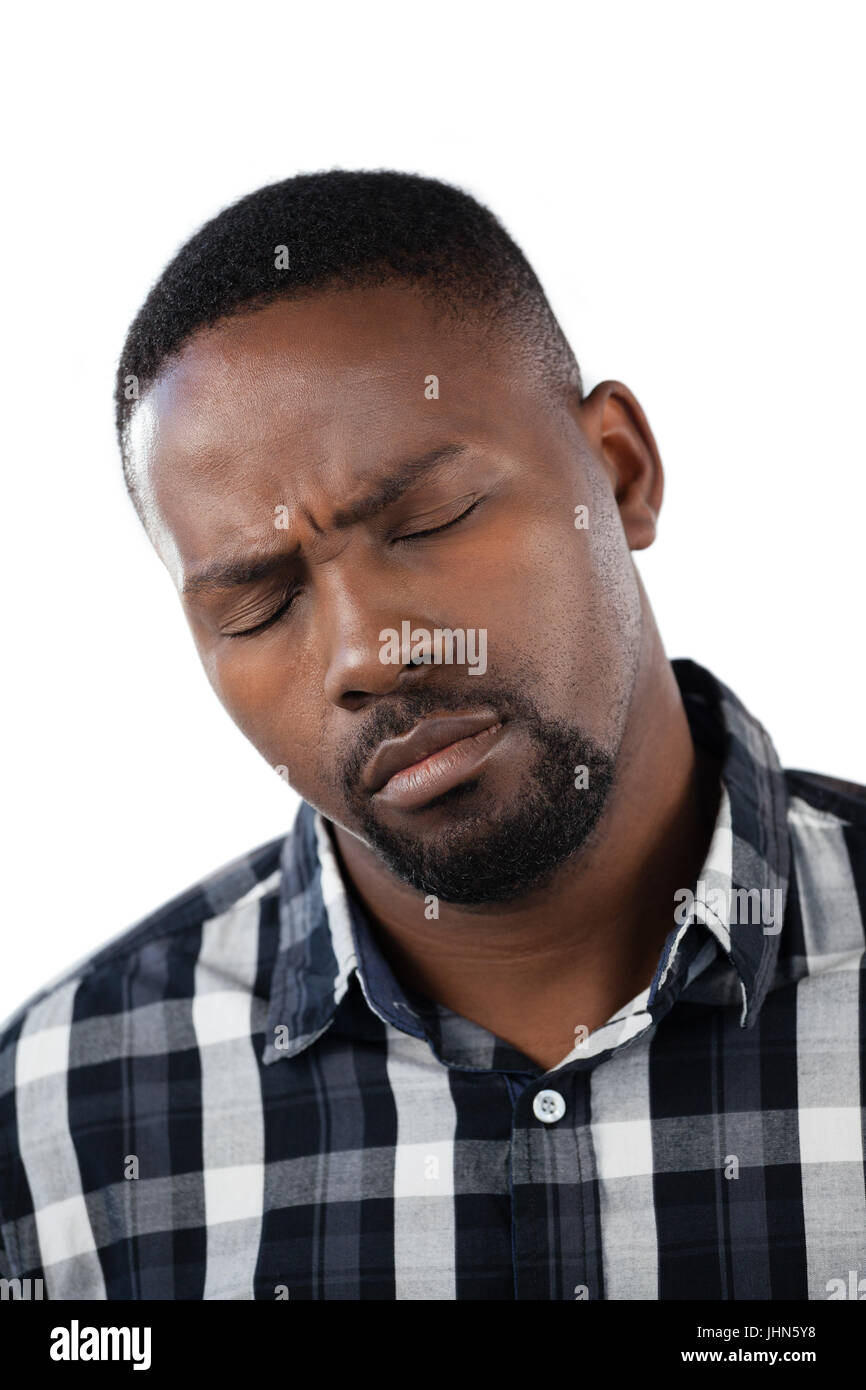 Tensed man against white background Stock Photo - Alamy