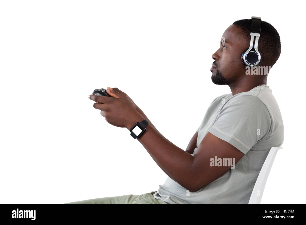 Side view of man playing video game against white background Stock ...