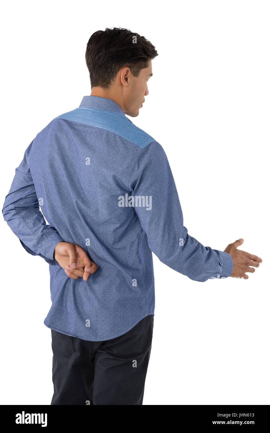 Rear view of businessman extending arm for handshake with fingers ...