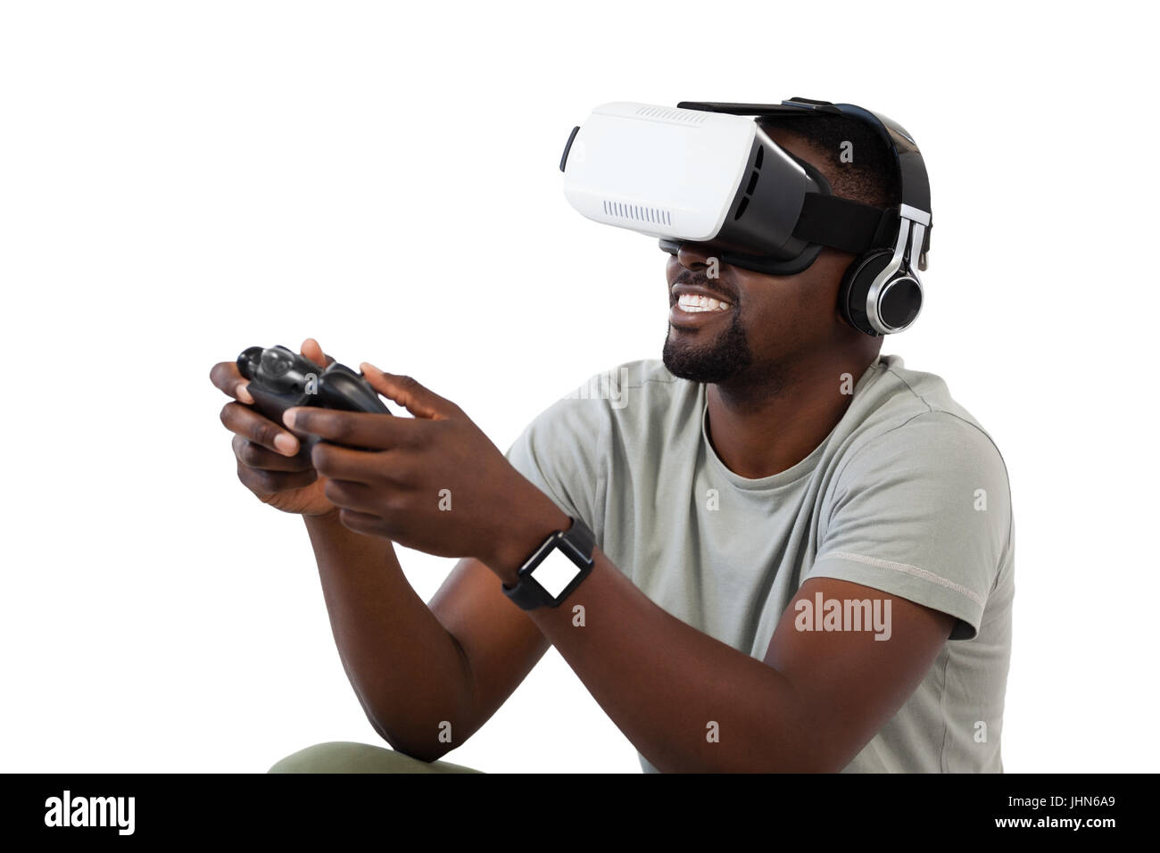Man using virtual reality headset and playing video game against white ...