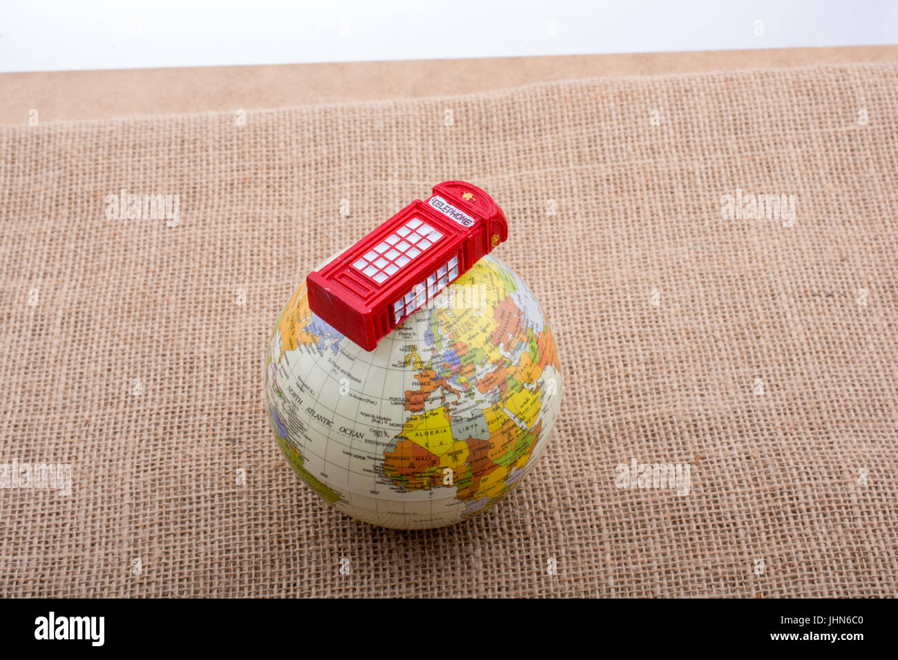 Globe with a telephone booth on canvas background Stock Photo - Alamy