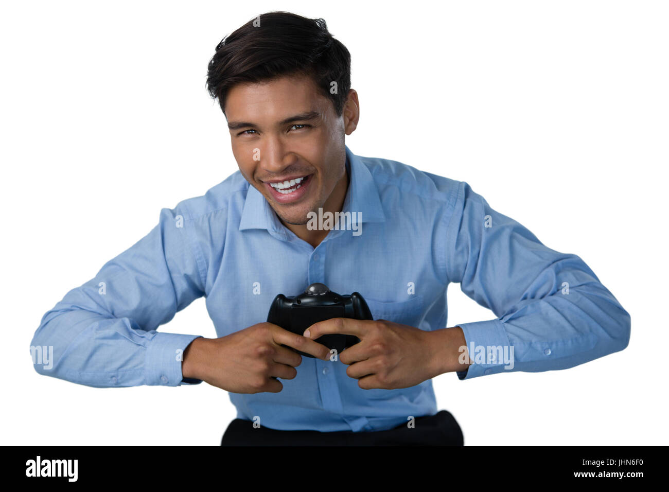 Portrait of happy businessman playing video game against white ...