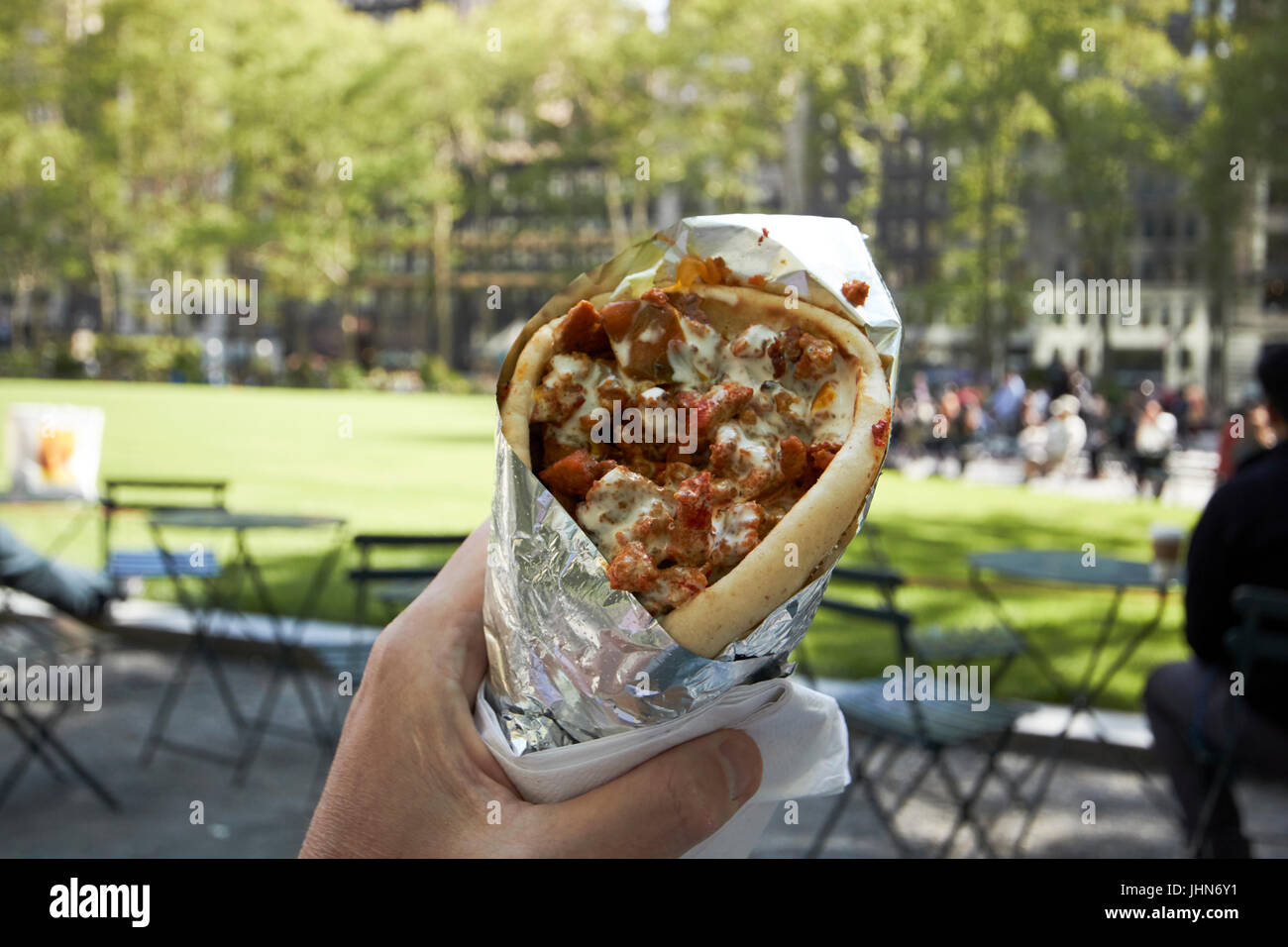 eating lamb gyro outdoors in bryant park at lunchtime New York City USA ...