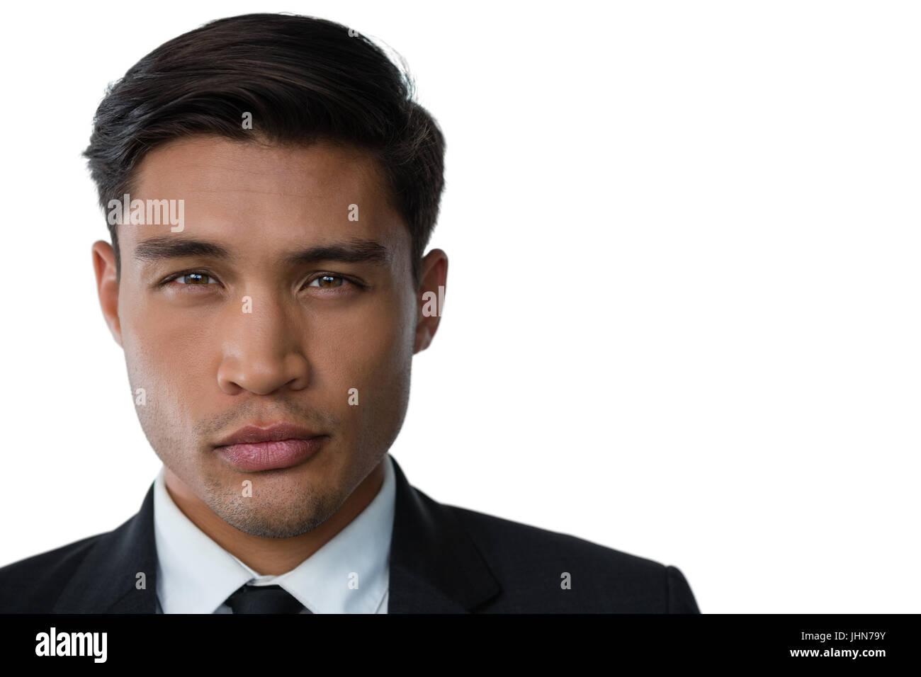 Close up portrait of young confident businessman against white ...