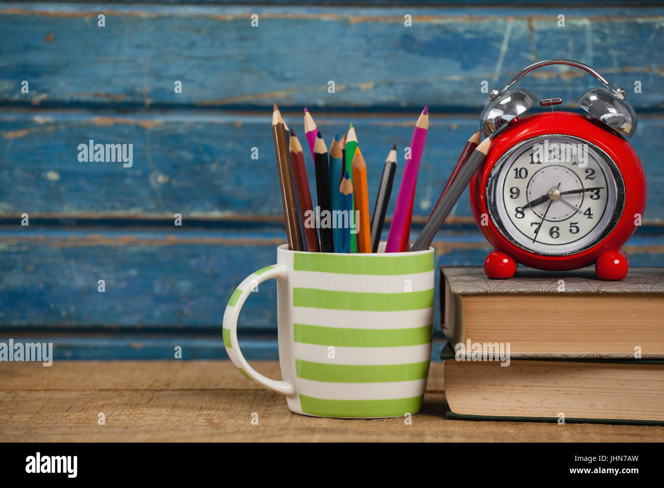 Books pen holder blue wooden background hi-res stock photography and ...