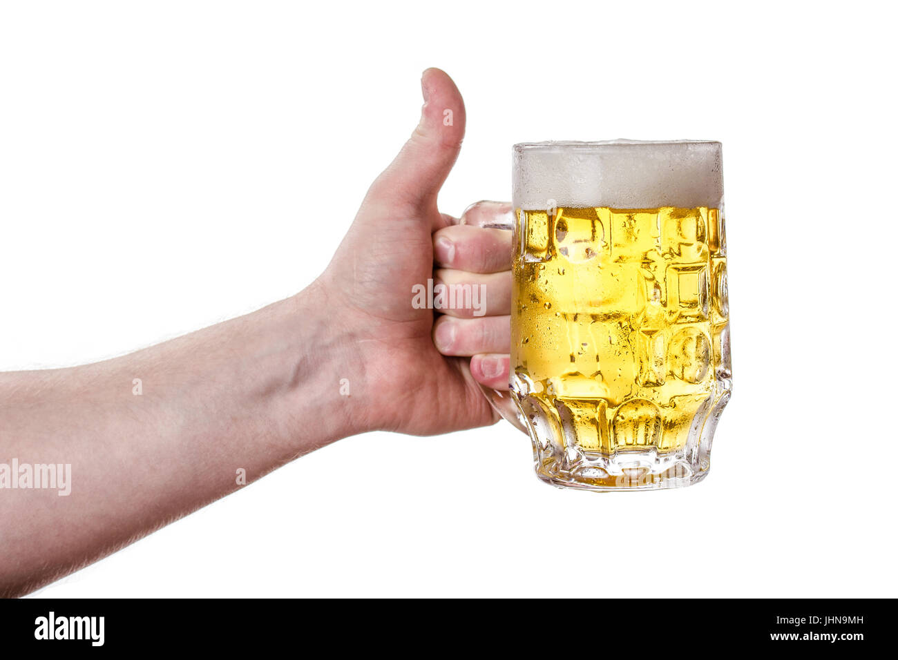 A mug of light beer in his hand. Isolated background Stock Photo - Alamy