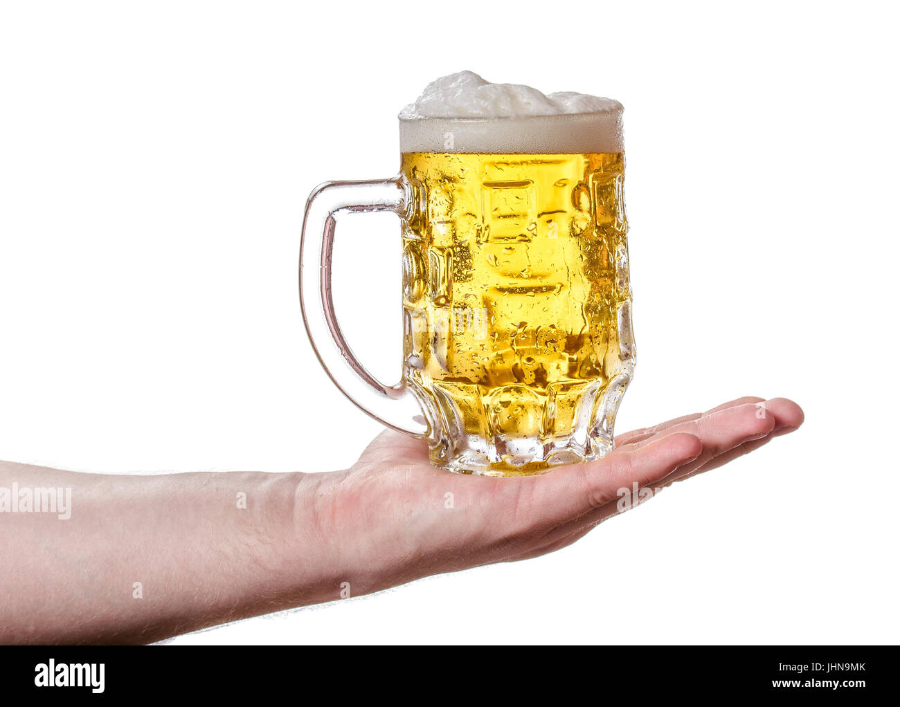 A mug of light beer in his hand. Isolated background Stock Photo - Alamy