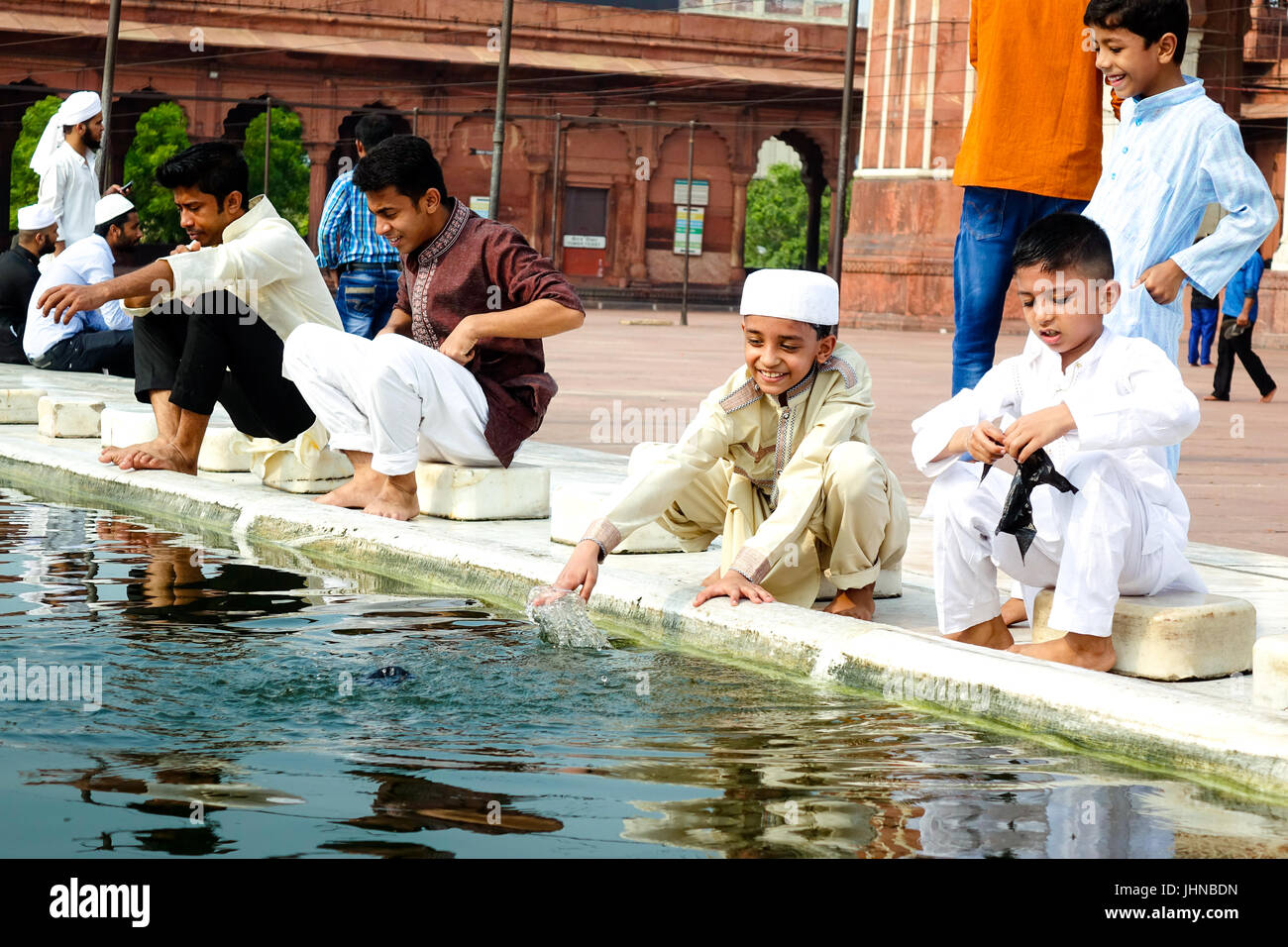 Children playing in ablution pond in Jama Masjid on sidelines of eid al ...