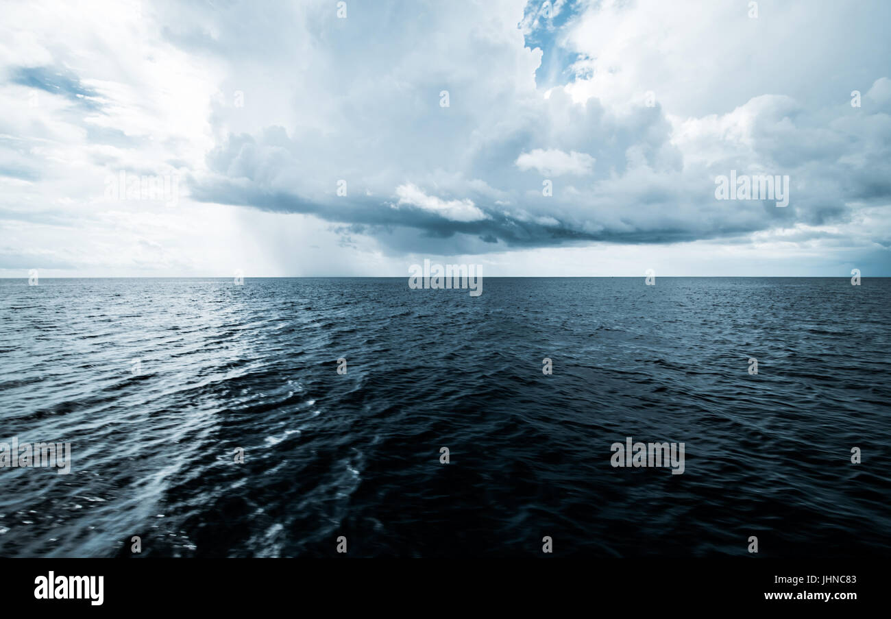 Dark clouds in open ocean Stock Photo - Alamy