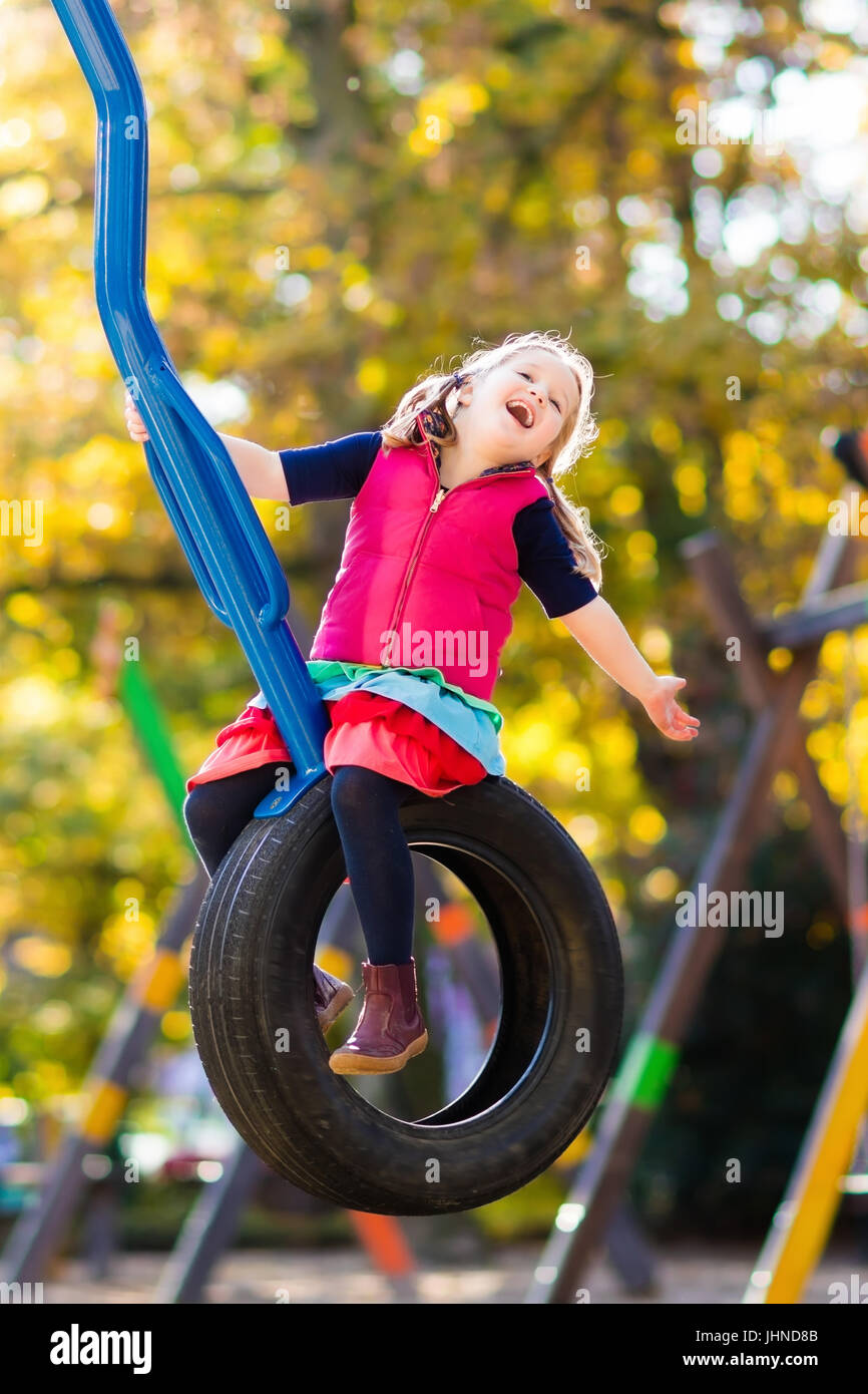 Kids on playground Children play in autumn park. Child on slide and ...