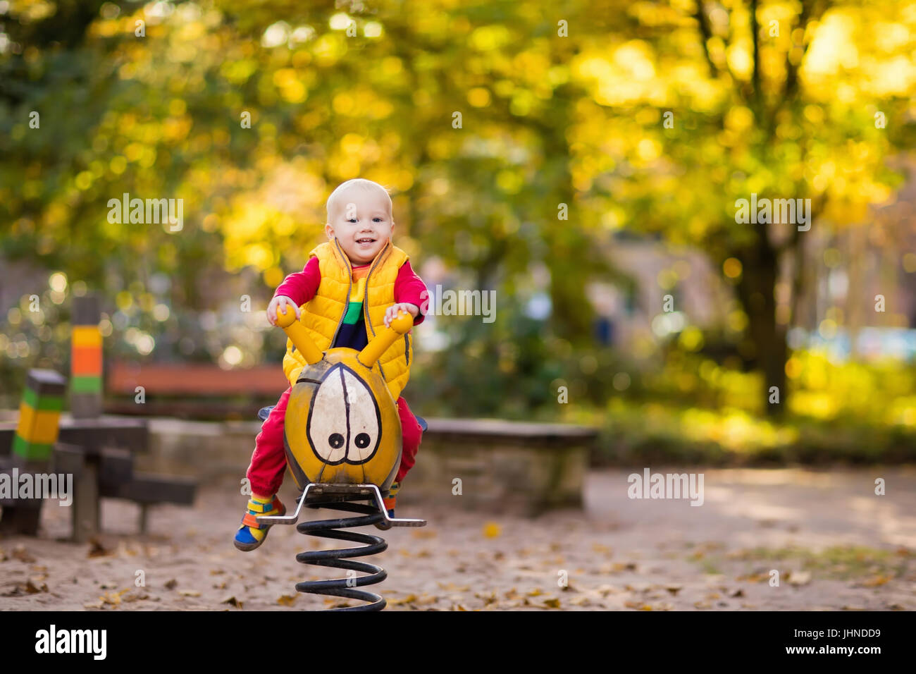 Kids on playground Children play in autumn park. Child on slide and ...