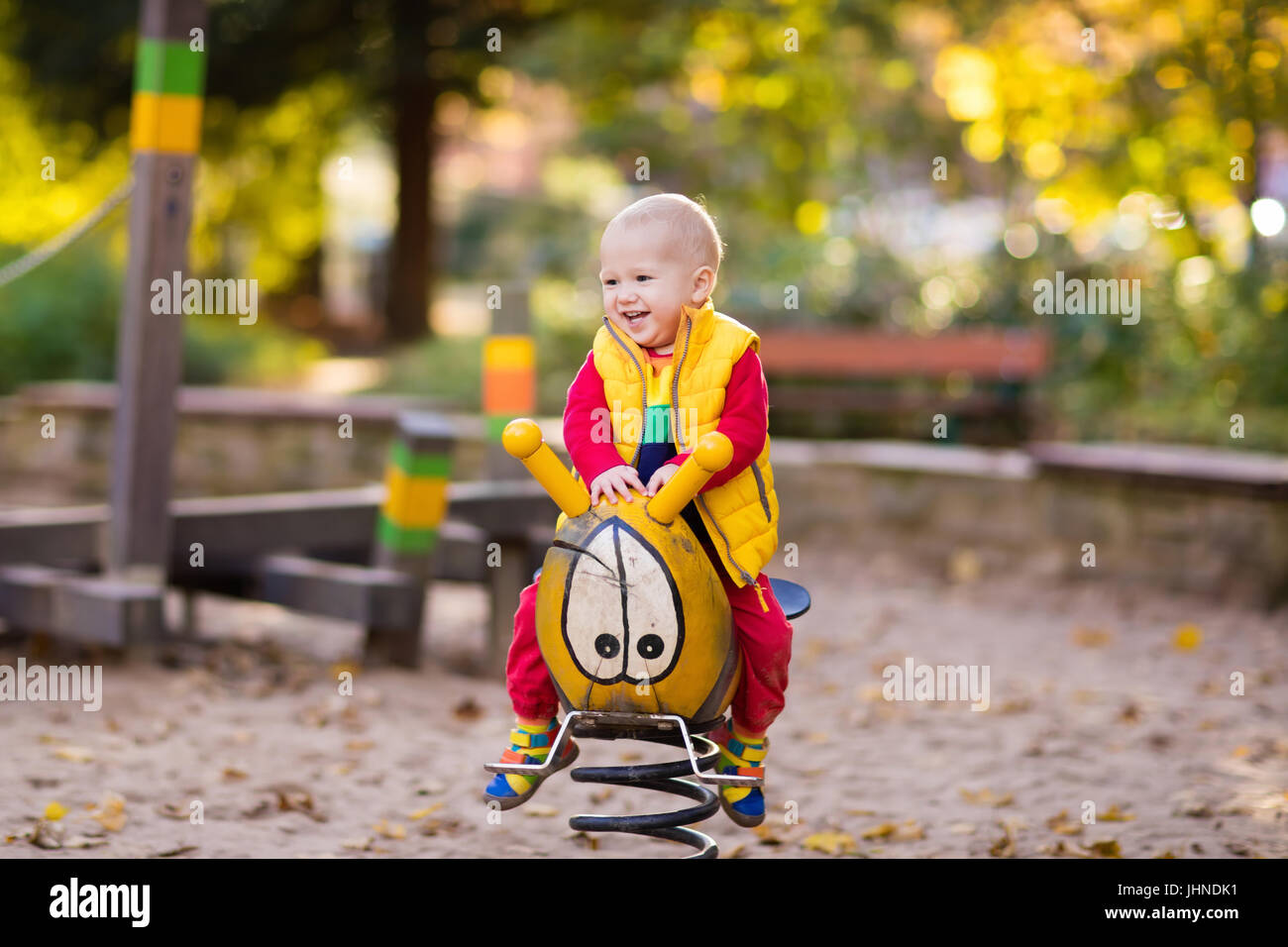 Kids on playground Children play in autumn park. Child on slide and ...