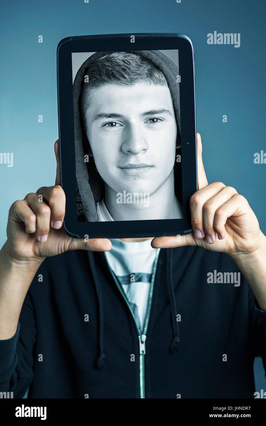 portrait of boy holding tablet with his face on it Stock Photo - Alamy